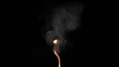 A weak fire source ignites gray smoke on... | Stock Video | Pond5