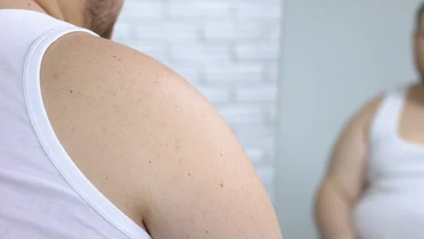 Weak muscles man looking at his arm in m... | Stock Video | Pond5