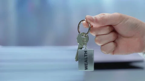 Wealth written on keychain hand giving f... | Stock Video | Pond5