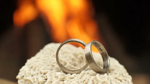 Wedding rings on a background of fire. | Stock Video | Pond5