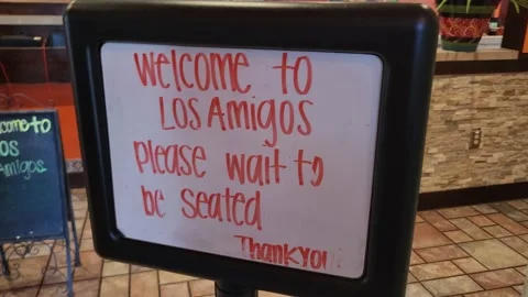 Welcome to Los Amigos Please Wait to Be ... | Stock Video | Pond5
