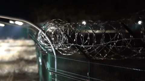 Welded wire mesh fence line with lightin... | Stock Video | Pond5