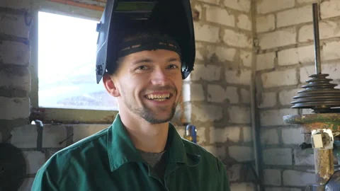 Welder smiling and looking at camera. Po... | Stock Video | Pond5