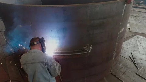 A welder welds a metal part, top view. W... | Stock Video | Pond5