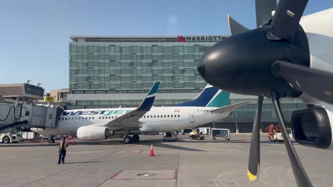 WestJet Airplane Parking at Airport Gate... | Stock Video | Pond5