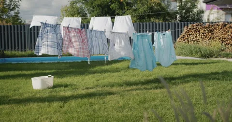 Wet clothes drying in the backyard of th... | Stock Video | Pond5