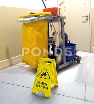 Wet floor signage with cleaning tools in background ~ Premium Photo ...