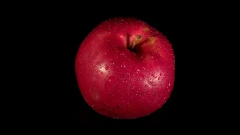 Wet red apple rotating on black backgrou... | Stock Video | Pond5
