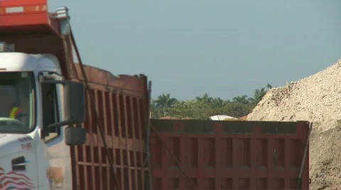 Wheeled loader loading dump truck in con... | Stock Video | Pond5