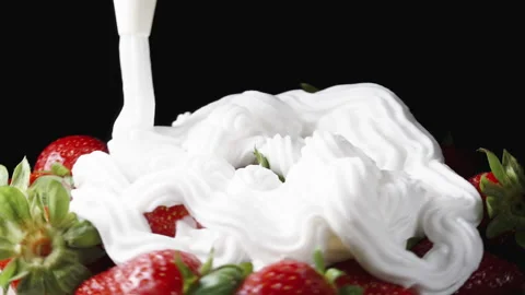 Whipped cream is being squeezed from a p... | Stock Video | Pond5