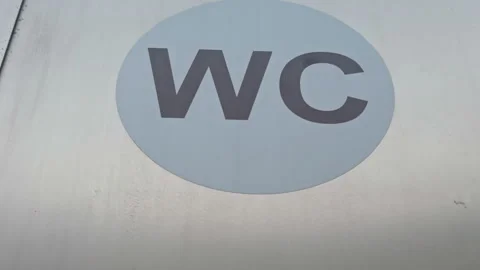A white and blue WC sign on metal indica... | Stock Video | Pond5