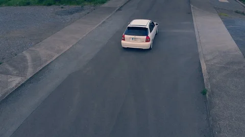 White car driving on the road, aerial fo... | Stock Video | Pond5