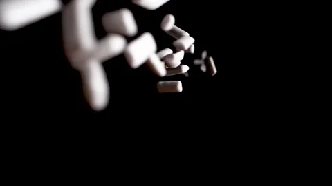 White Chewing Gum Tablets Falling in Bla... | Stock Video | Pond5