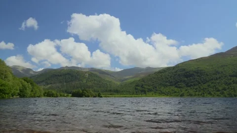 White clouds billowing over forested mou... | Stock Video | Pond5