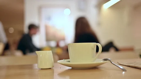 White cup of coffee in a restaurant, peo... | Stock Video | Pond5