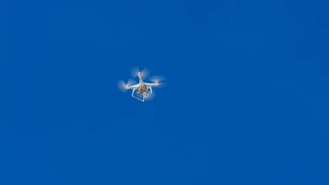A white drone flying with dark blue sky ... | Stock Video | Pond5