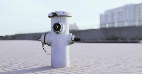 White fire hydrant on sandy beach with b... | Stock Video | Pond5