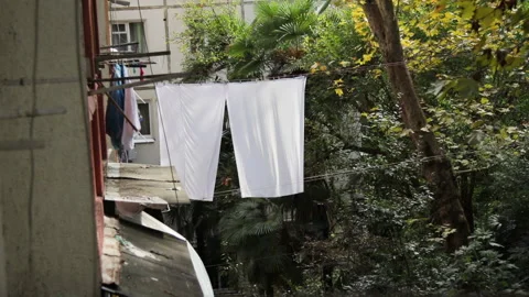 White laundry hanging on the rope outdoo... | Stock Video | Pond5