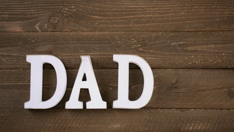 White letters DAD on a painted wood back... | Stock Video | Pond5
