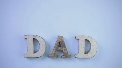 White letters DAD on a painted wood back... | Stock Video | Pond5