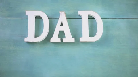 White letters DAD on a painted wood back... | Stock Video | Pond5