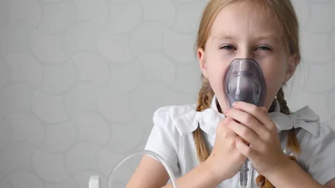white little girl makes inhalation with ... | Stock Video | Pond5