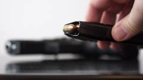 White Male hand placing on table 9mm mag... | Stock Video | Pond5