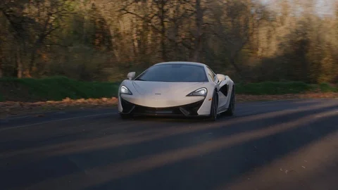 White McLaren car driving on track at su... | Stock Video | Pond5