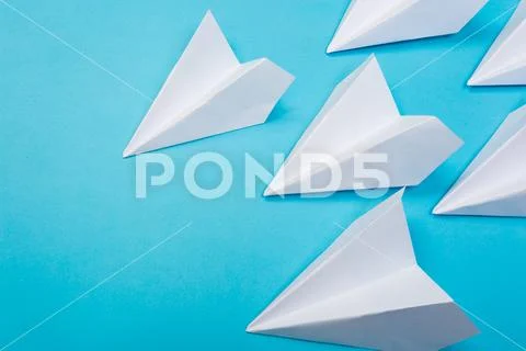 White paper airplane on a navy paper background ~ Premium Photo #115240694