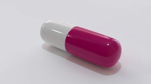 White - pink medicinal capsule on a whi... | Stock Video | Pond5