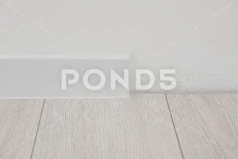 White plinth on laminated floor in room Stock Photo #243566050