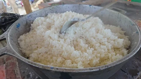 White rice preparation in an iron pot, c... | Stock Video | Pond5