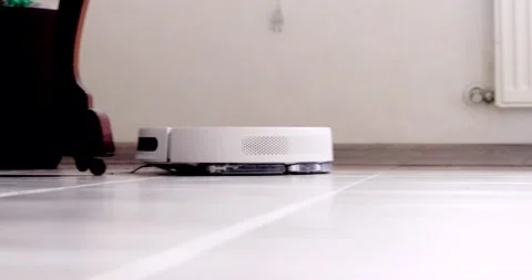 white robot duster at speed cleans the f... | Stock Video | Pond5