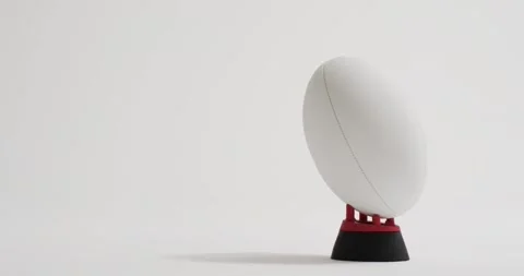 White rugby ball on kicking tee on white... | Stock Video | Pond5