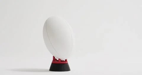 White rugby ball on kicking tee on white... | Stock Video | Pond5