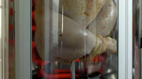 Whole chicken roasting rotating inside e... | Stock Video | Pond5