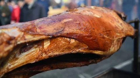 Whole lamb roasting on a spit over charc... | Stock Video | Pond5