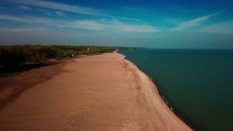 Wide aerial flyover sandy beach along th... | Stock Video | Pond5