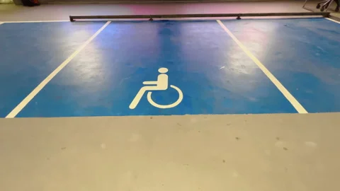 Wide angle: Blue disabled sign at underg... | Stock Video | Pond5
