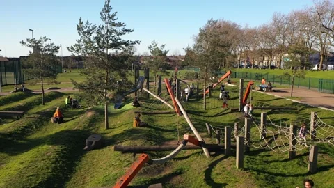 wide panning shot of children playing in... | Stock Video | Pond5
