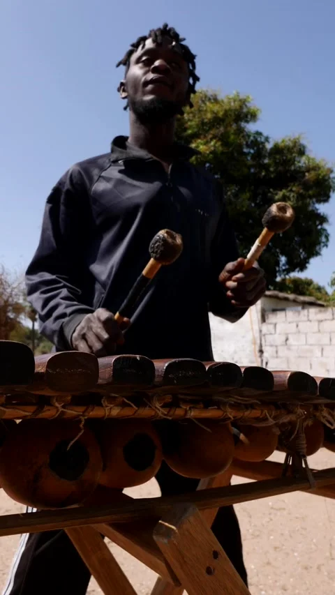 Wide shot of black man playing Balafon i... | Stock Video | Pond5