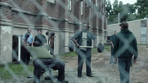 Wide shot of inmates and guards outdoor ... | Stock Video | Pond5