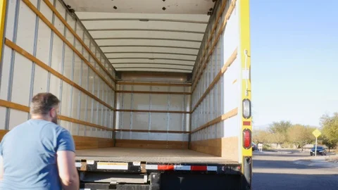 Wide Shot of a Man Pushing In a Metal Ra... | Stock Video | Pond5