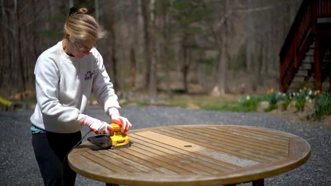 Wide shot of mature woman sanding a teak... | Stock Video | Pond5