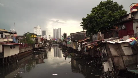 Wide shot of slum houses next to a trash... | Stock Video | Pond5