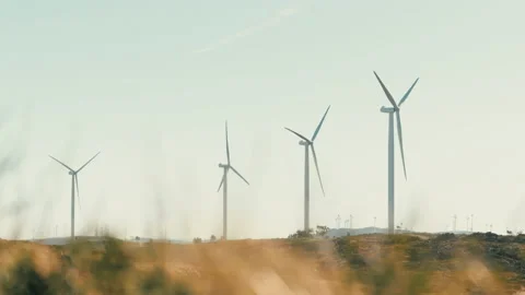 A wide shot of wind turbines surrounded ... | Stock Video | Pond5