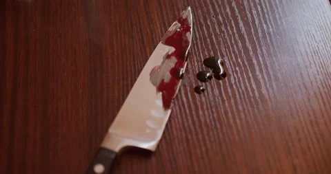 Wide Tilt of a Bloody Knife on a Table | Stock Video | Pond5