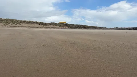 Wind blowing sand across the beach | Stock Video | Pond5