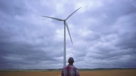 Wind turbine energy with man walking in ... | Stock Video | Pond5