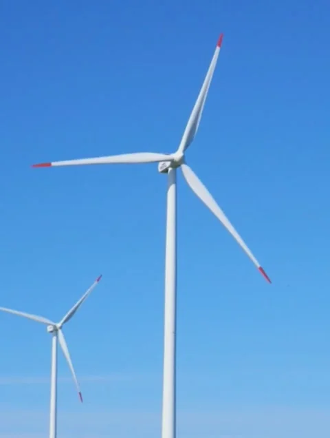 Wind turbines in motion with clear sky i... | Stock Video | Pond5